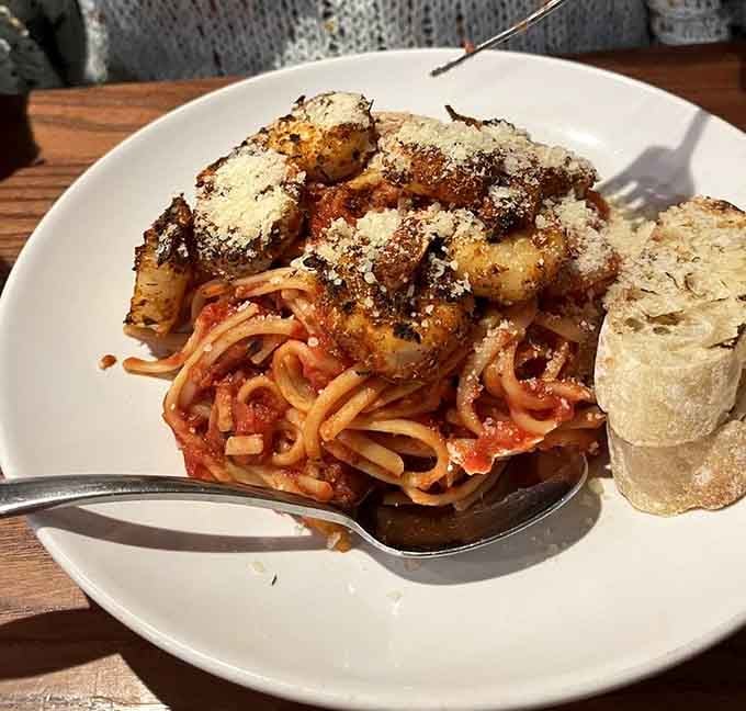 Those meatballs perched atop spaghetti like edible crown jewels deserve their own standing ovation and possibly a parade.