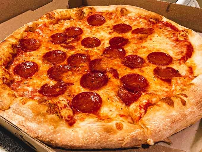 Pepperoni pizza emerges golden and bubbling, a classic done well with generous toppings and perfectly crispy crust.