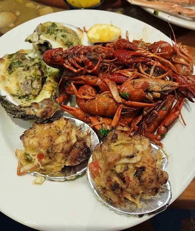 Crawfish, oysters Rockefeller, and stuffed clams create a seafood symphony that would make any coastal grandmother absolutely proud.