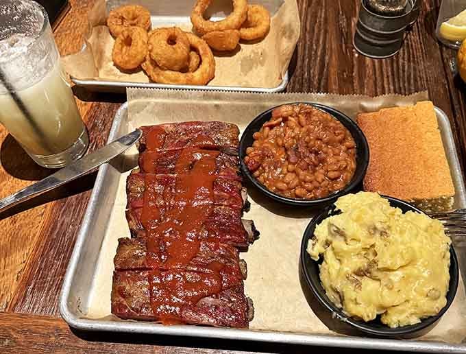 St. Louis-style ribs glazed to perfection, served with sides that could headline their own show entirely.