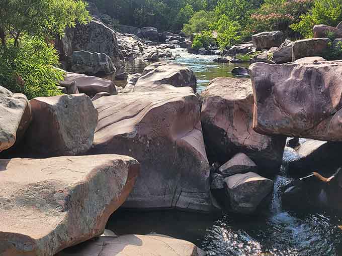 Pink and gray rhyolite formations stack like nature's own abstract sculpture garden, each boulder telling an ancient volcanic story.