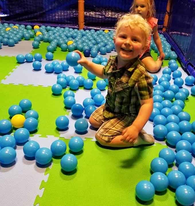 Ball pit bliss captured in one gleeful expression, proving happiness doesn't require a single electronic device or screen.