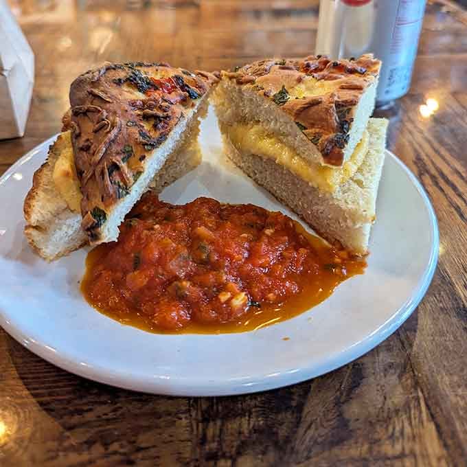 Melted cheese cascading over crispy bread with a side of rich sauce, because restraint is overrated.