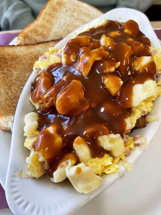 Breakfast poutine with gravy-drenched cheese curds and scrambled eggs redefines what morning comfort food can be.