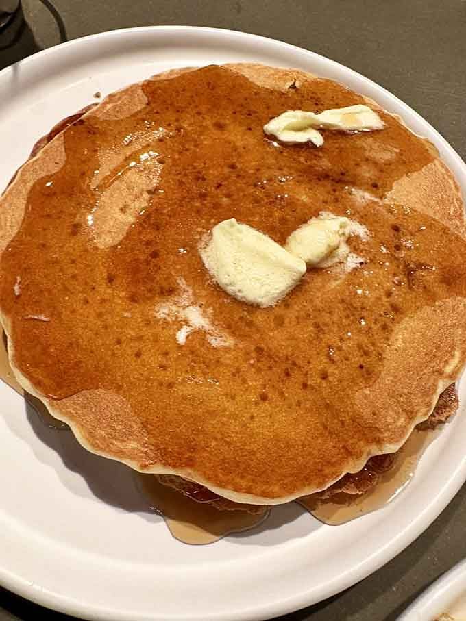 Perfectly golden pancakes with butter pats melting into sweet pools, just like Sunday mornings at grandma's house always were.