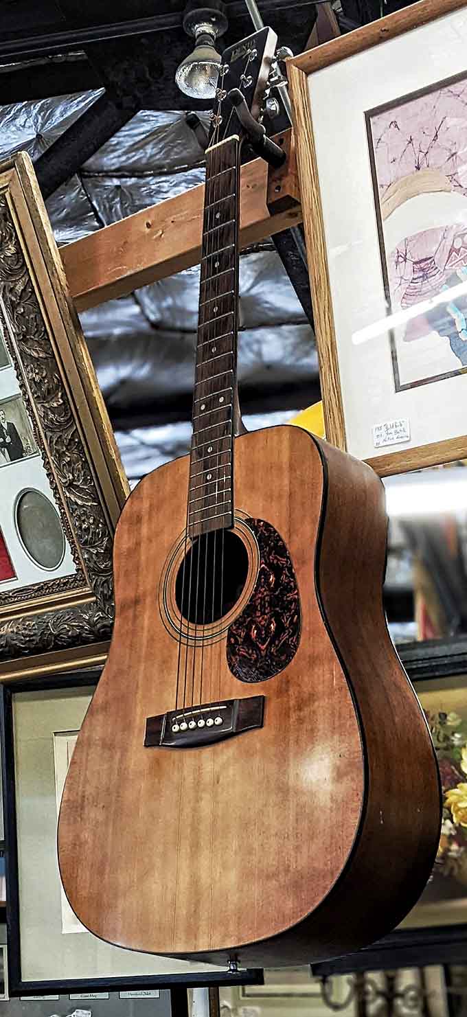 This acoustic guitar has probably serenaded more campfires and living rooms than it can remember, and still looks ready.