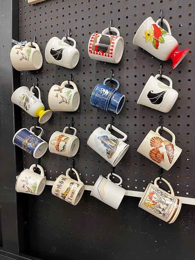 Vintage mugs hanging like art, because apparently our ancestors needed specialized cups for literally everything they drank.