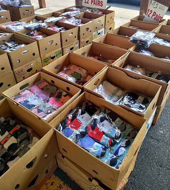 Cardboard boxes overflow with socks by the dozen, proving practical shopping can still feel like discovering buried treasure.