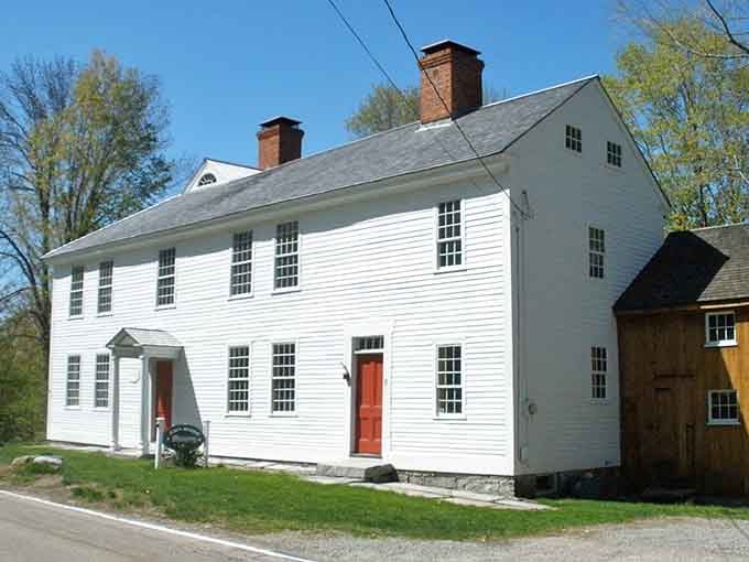 Colonial homes line the route like sentinels of history, their white clapboards gleaming with centuries of New England pride.
