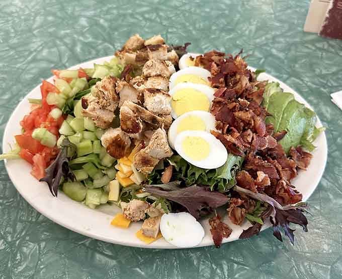 The Cobb salad arrives loaded with more toppings than a Supreme Court case, and it's far more satisfying.
