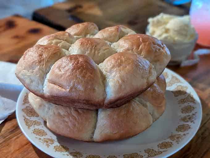 Fresh-baked rolls stacked like a delicious tower, warm and ready to soak up every last bit of flavor from your plate.