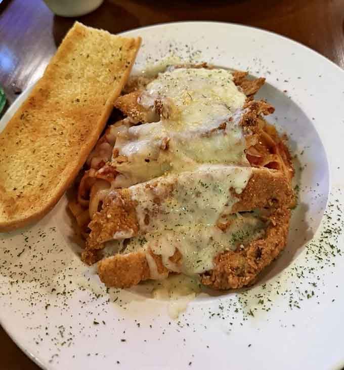 Golden-fried chicken parmesan over fettuccine brings Italian-American comfort food to its delicious, cheesy peak of perfection.