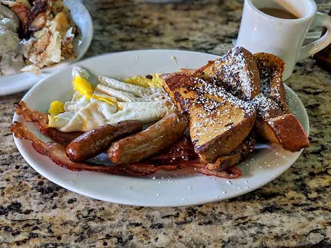 French toast dusted with powdered sugar alongside crispy bacon creates a sweet-and-savory symphony on your plate.