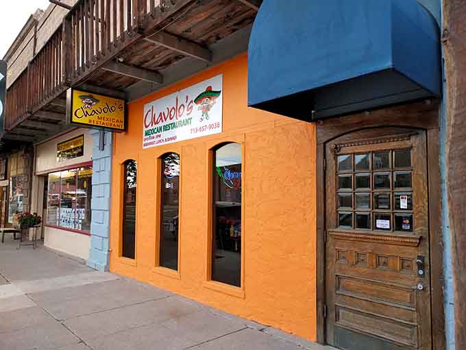 Chavolo's bright orange storefront pops against the historic buildings like a cheerful neighbor who always waves hello.