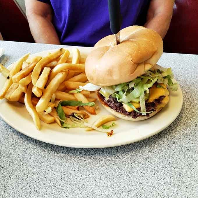 Golden fries flanking a loaded burger create the kind of plate that makes diet plans suddenly seem negotiable.