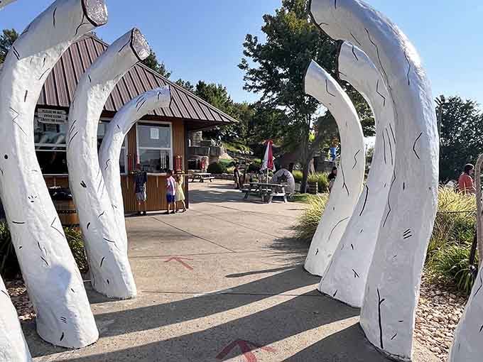Step through the bones of giants and into a world where your golf score matters more than survival instincts.