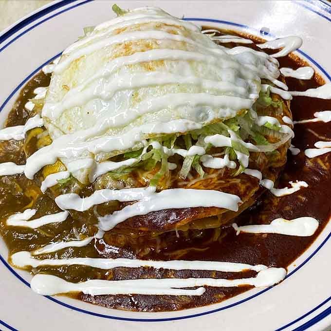 Stacked enchiladas drizzled with enough sauce to make you forget you're technically eating breakfast, not dinner.