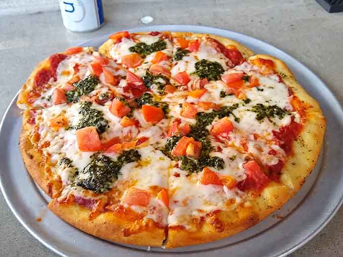 Fresh pizza loaded with vegetables proves that even when you're trying to be somewhat responsible, you're still having an absolutely fantastic time here.