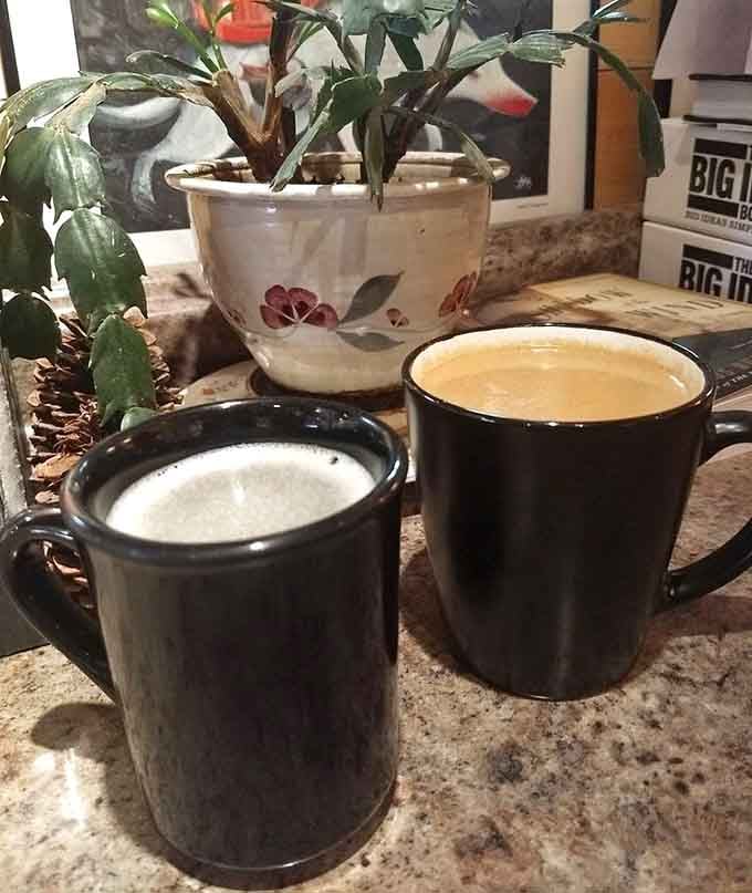 Two steaming mugs and a vintage planter create an inviting tableau that practically begs you to stay.