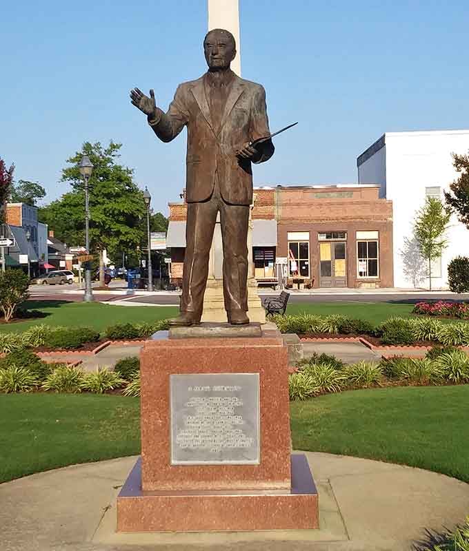 A bronze statue that commands respect while the pigeons plot their next landing strategy from nearby trees.