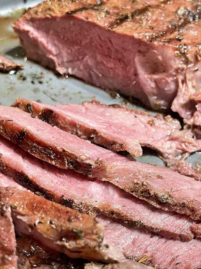 This tomahawk steak means business, sliced thick and juicy enough to make any carnivore weep with joy.