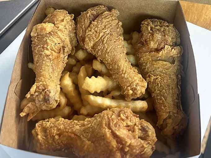 Drumsticks with that gorgeous golden coating sitting atop a mountain of fries is pure comfort food poetry.