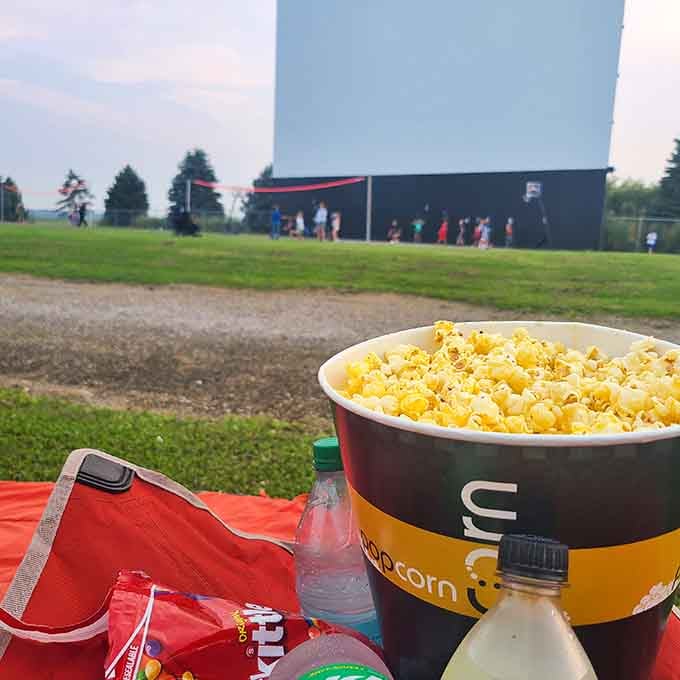 That giant bucket of buttery popcorn is basically a food group when you're at the drive-in.