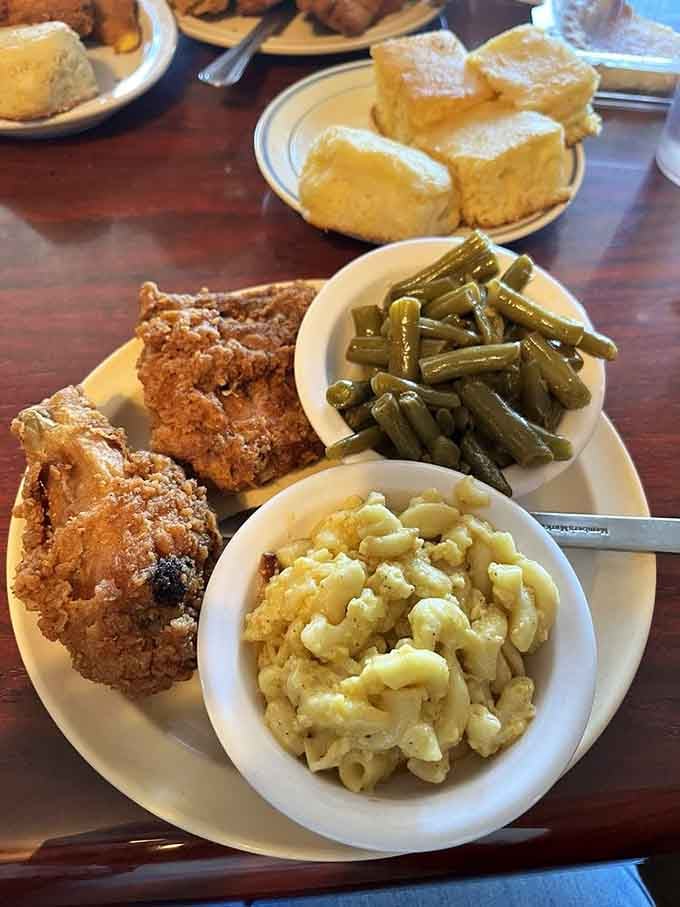 Fried chicken so perfectly golden it practically glows, served with green beans and cornbread that complete the Southern trinity.