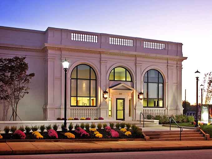Classical columns and arched windows glow at twilight, transforming this elegant structure into an architectural jewel worth admiring.