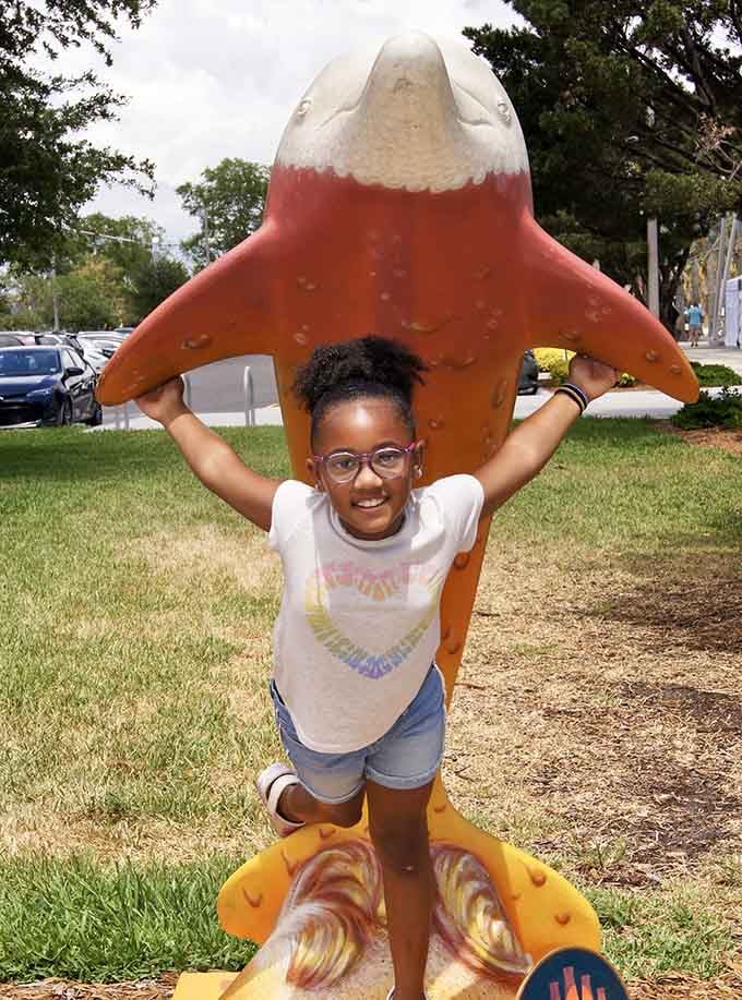 A dolphin sculpture doubles as the perfect photo op, where childhood memories are made in brilliant shades of orange and cream.