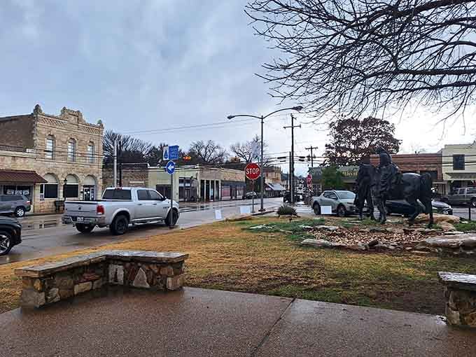 Stone benches and historic buildings create the kind of town square where time moves at exactly the right speed.