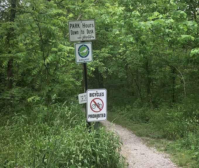 Trail markers guide visitors through Eagle Creek Park's natural beauty, where bicycles wisely stay grounded.