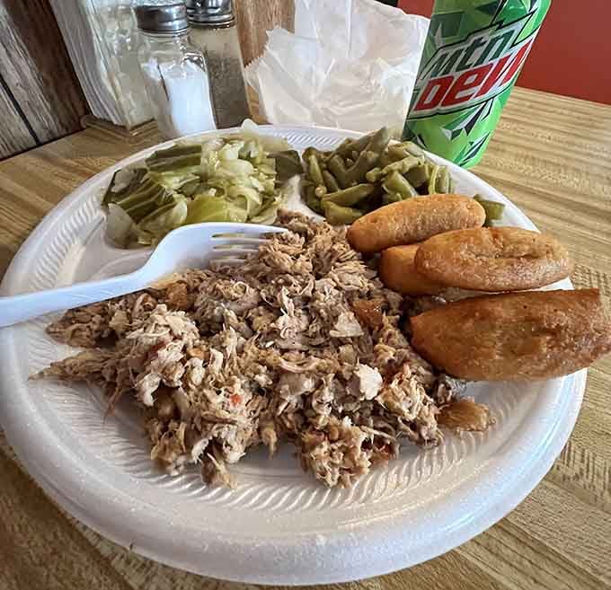 That pile of perfectly chopped barbecue with hush puppies and green beans is basically a love letter written in pork and smoke.