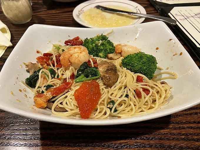 Garden pasta with shrimp and sun-dried tomatoes offers a lighter path for those pacing themselves before dessert.