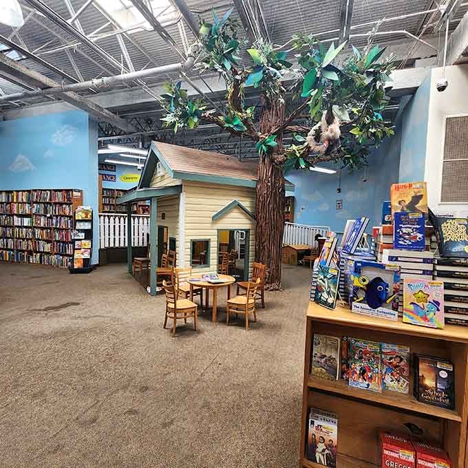 That decorative tree and cozy seating area prove reading spaces can be whimsical and welcoming at any age.