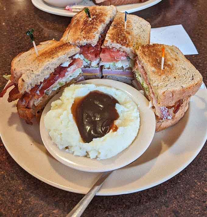 That towering club sandwich with mashed potatoes proves lunch items here deserve just as much attention as breakfast classics.
