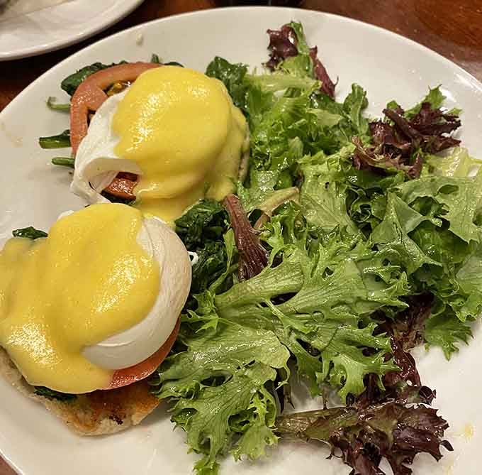 Those perfectly poached eggs with hollandaise so good you'll want to write home about it, served alongside fresh greens.