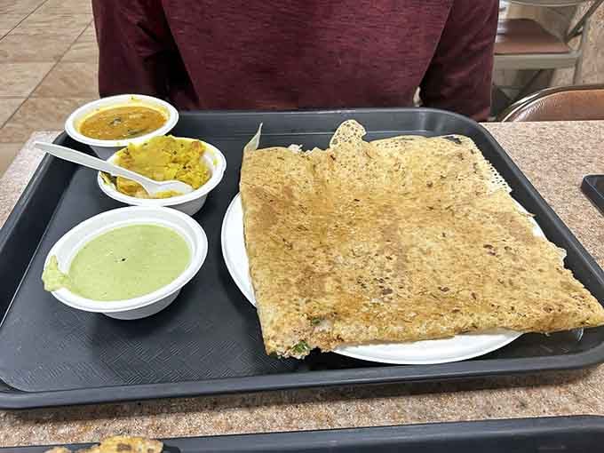 The rava dosa's lacy, crispy texture makes regular crepes look like they're not even trying to compete in this league.