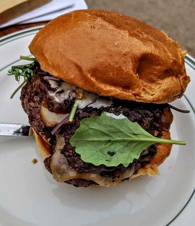 Holy Grale's signature burger towers like a delicious monument to everything right about American comfort food done exceptionally well.