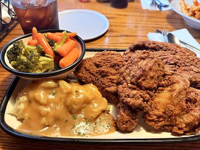 Fried chicken so massive it makes the vegetables look like they're just there for moral support.