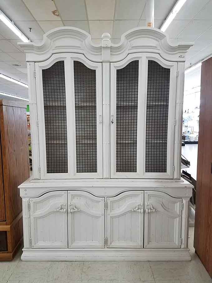 This elegant white china cabinet is begging for a makeover or ready to shine as-is in someone's dining room.