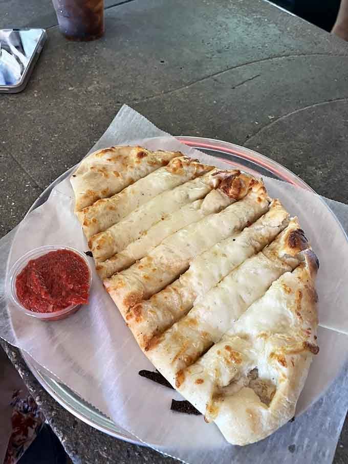 Cheesy bread sticks with marinara sauce, proving simplicity can be absolutely perfect when done right.