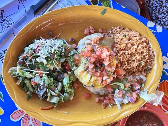 That golden oval platter loaded with rice, beans, and fresh pico proves comfort food speaks every language beautifully.