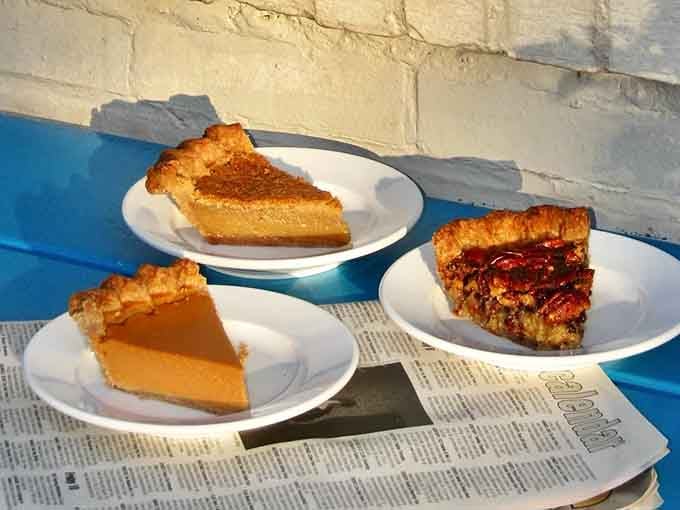 Three perfect pie slices on newspaper prove that sometimes the best things in life come with a flaky crust.