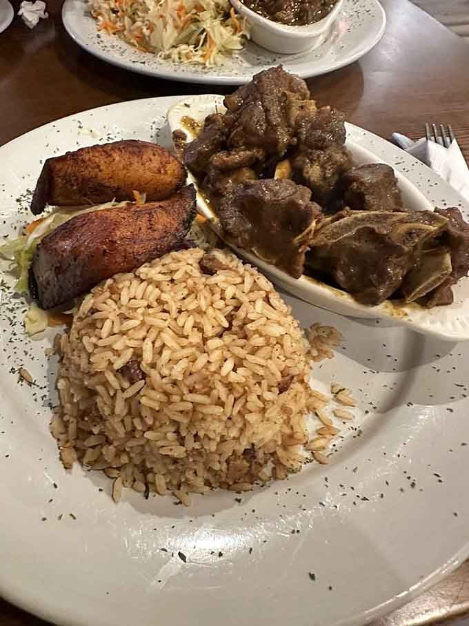 Curry goat with all the sides, converting skeptics into believers one magnificent bite at a time.