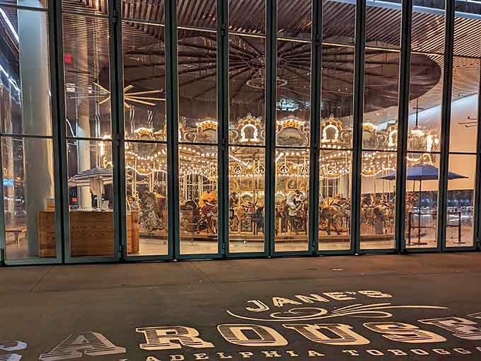 The illuminated carousel looks like someone gift-wrapped a piece of history in glass and light.
