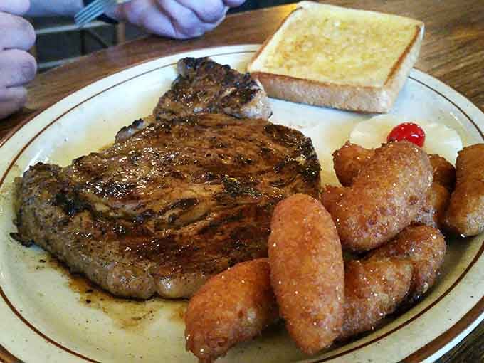 That ribeye looks like it could star in its own Western, surrounded by hush puppies playing supporting roles.