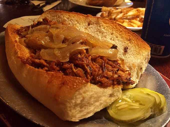 Pulled pork piled this high on a roll isn't just lunch, it's an architectural marvel you get to eat.