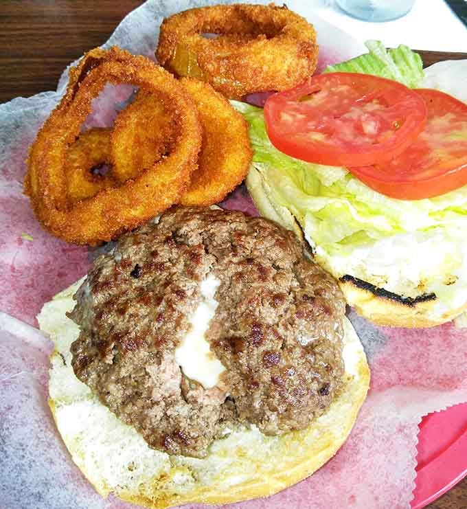 The Juicy Lucy burger with onion rings proves that some culinary marriages are made in diner heaven.