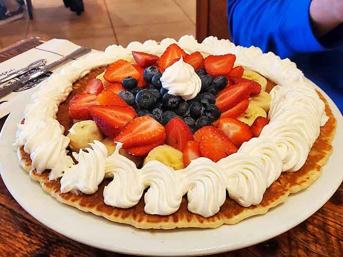 When your pancake looks like edible art covered in fresh berries, you've officially won breakfast.